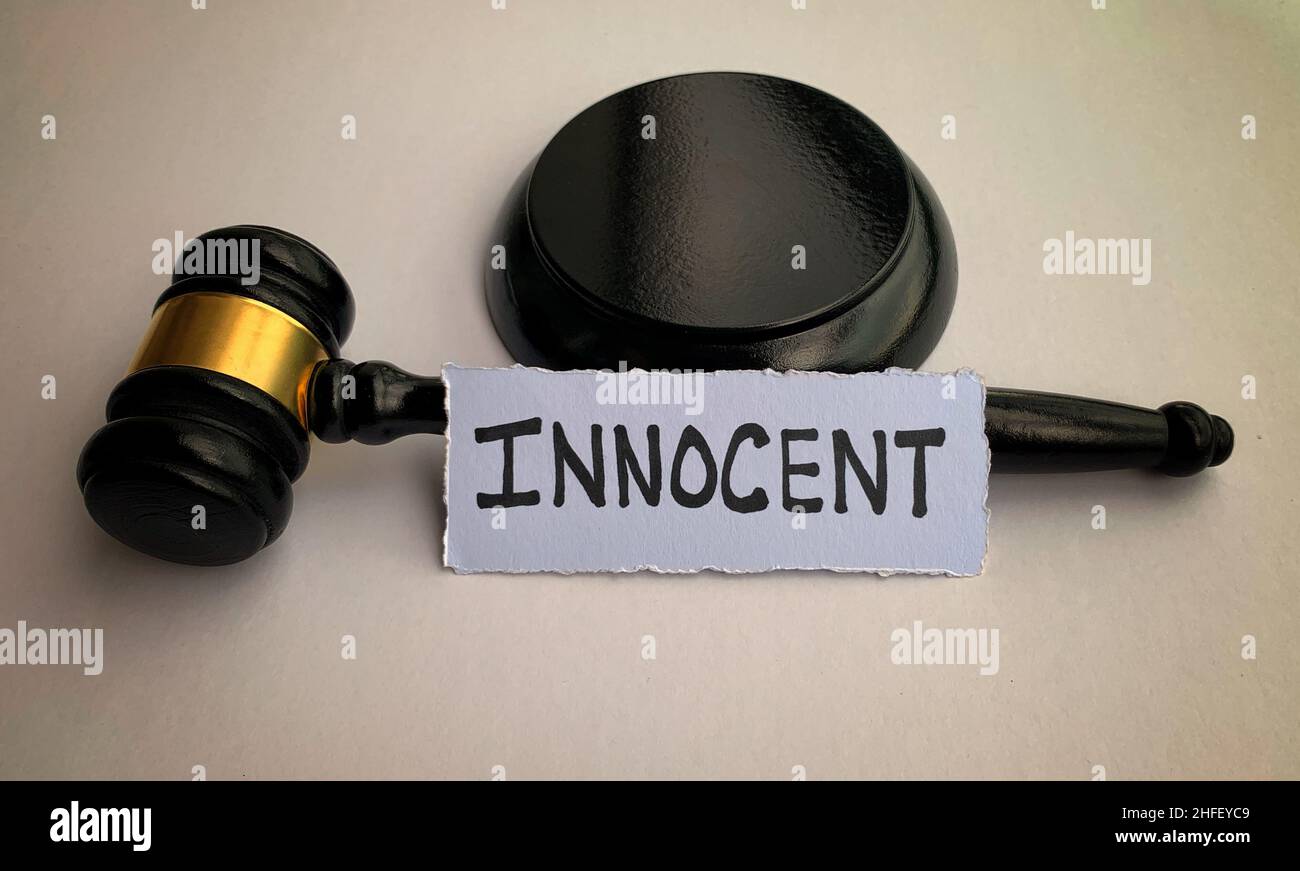 Judge gavel as concept of law of justice with innocent text on torn ...