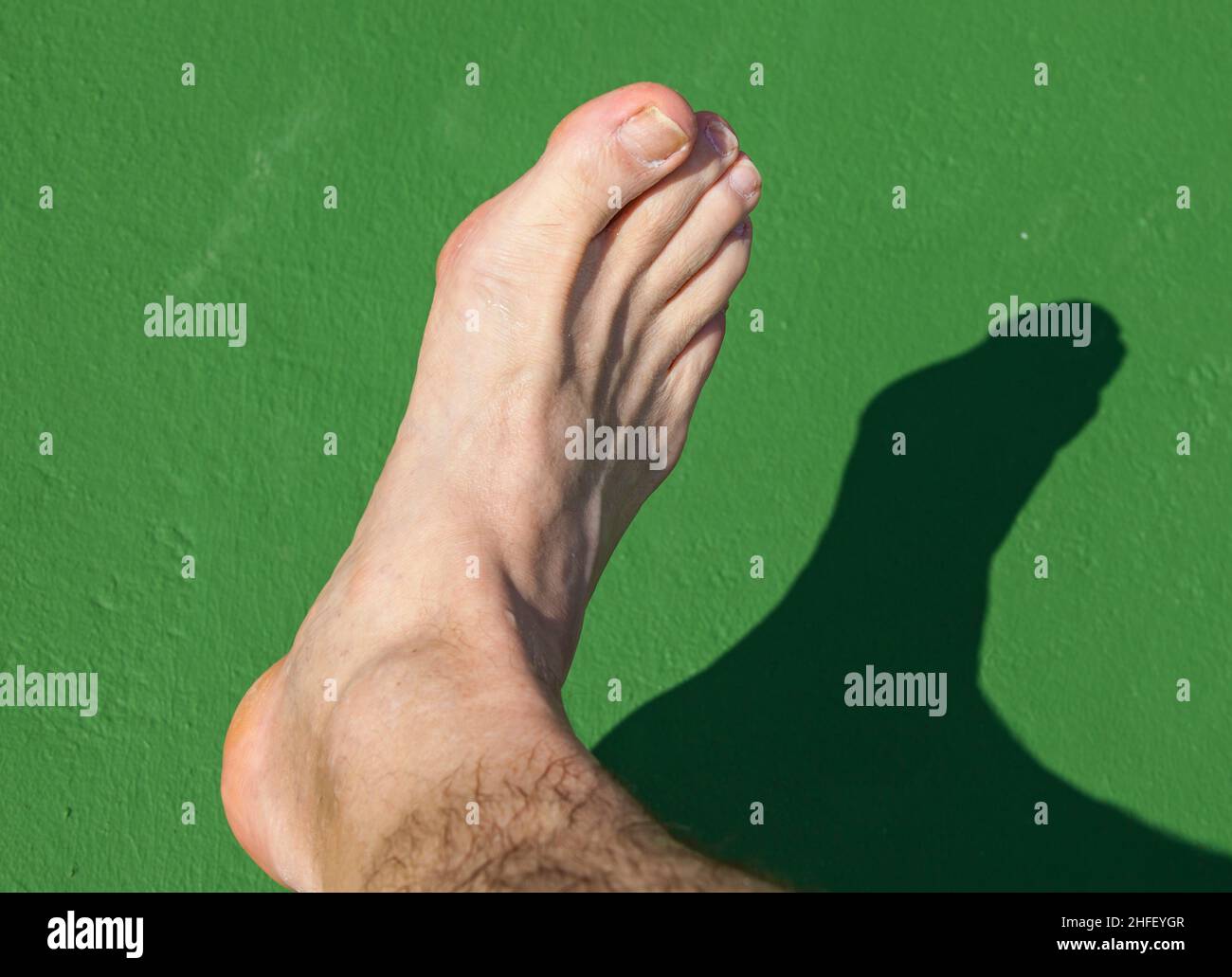 foot of man with shadow Stock Photo - Alamy