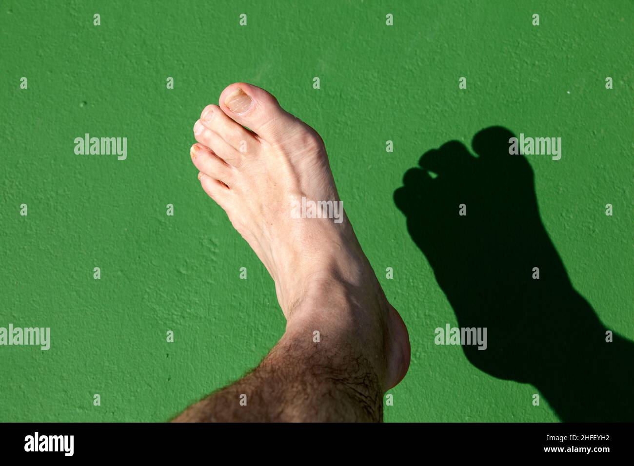 foot of man with shadow Stock Photo - Alamy