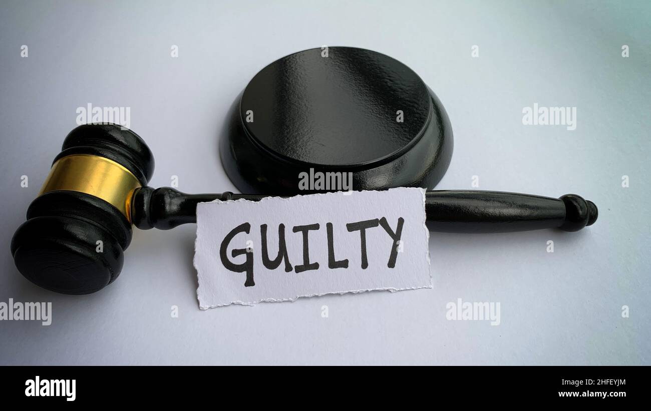 Guilty text on torn paper with judge gavel. Law concept Stock Photo - Alamy