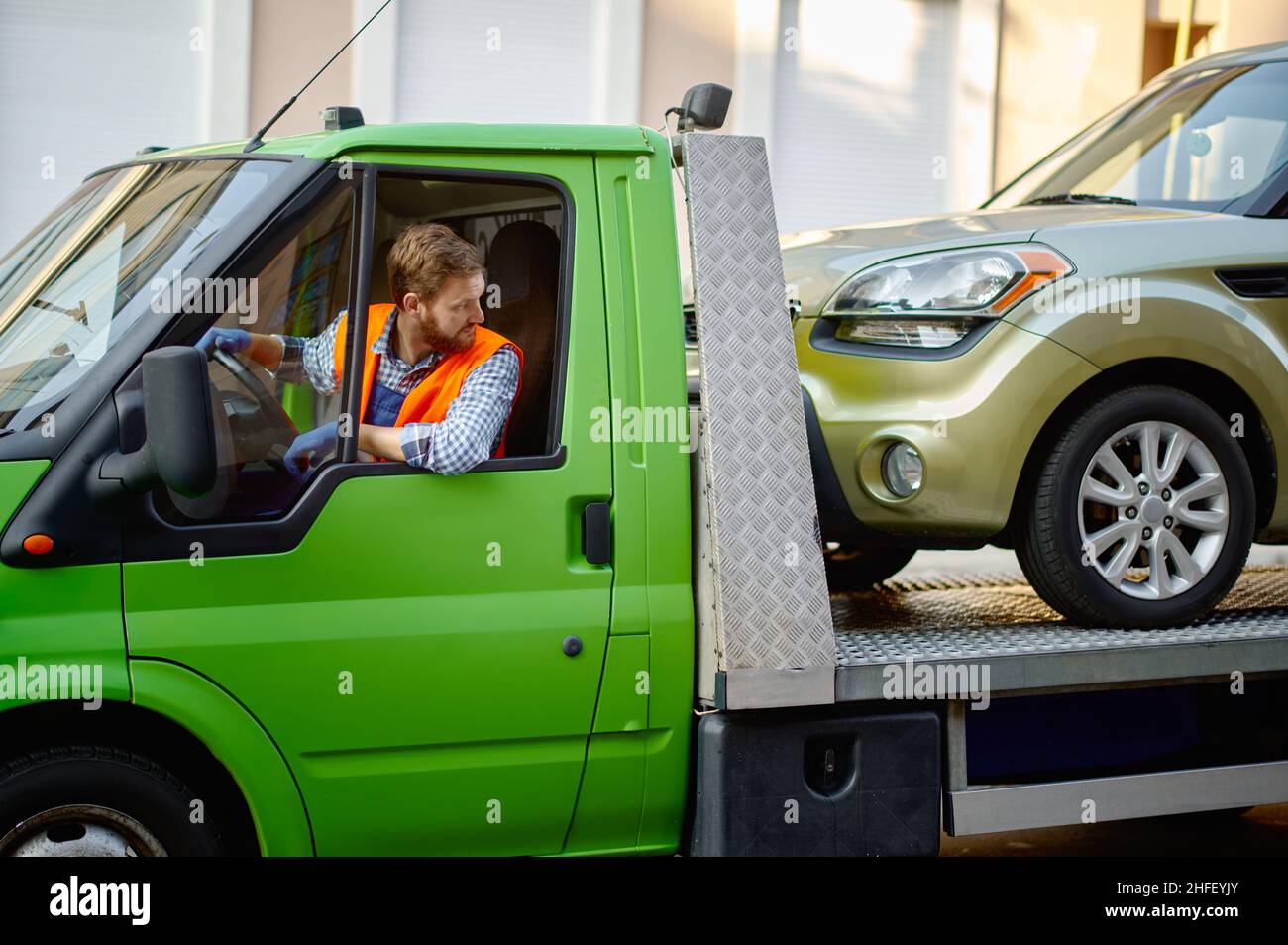 Tow truck driver delivering car to autoservice Stock Photo - Alamy