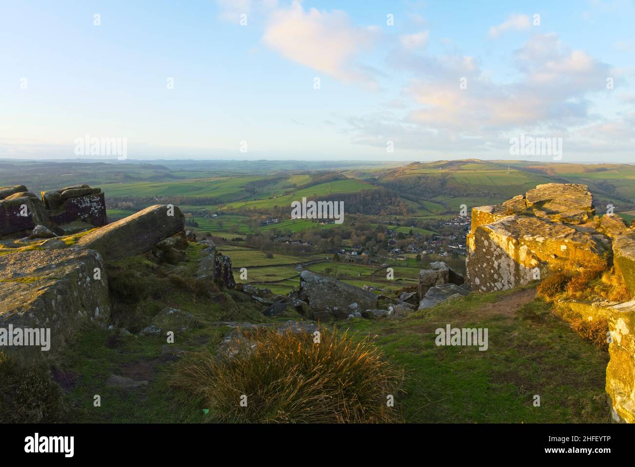 On a misty winter morning a gap between gritstone rocks reveals the ...