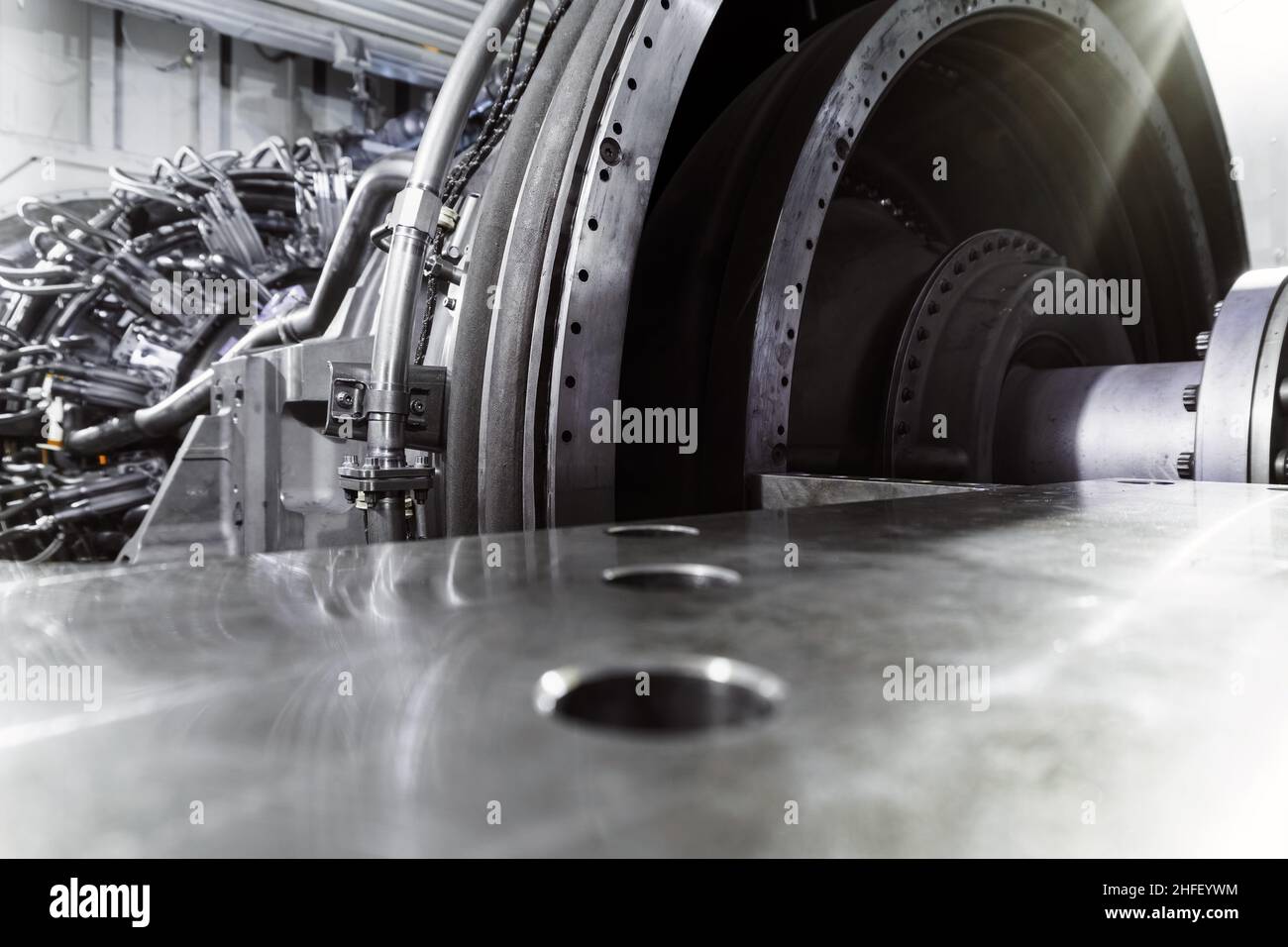 A gas turbine with a compressor rotor and a bolted coupling half ...