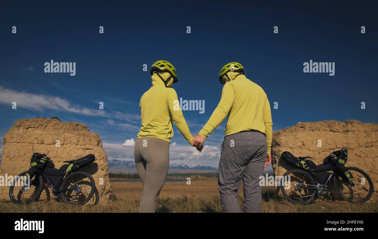 The man and woman travel on mixed terrain cycle touring with ...
