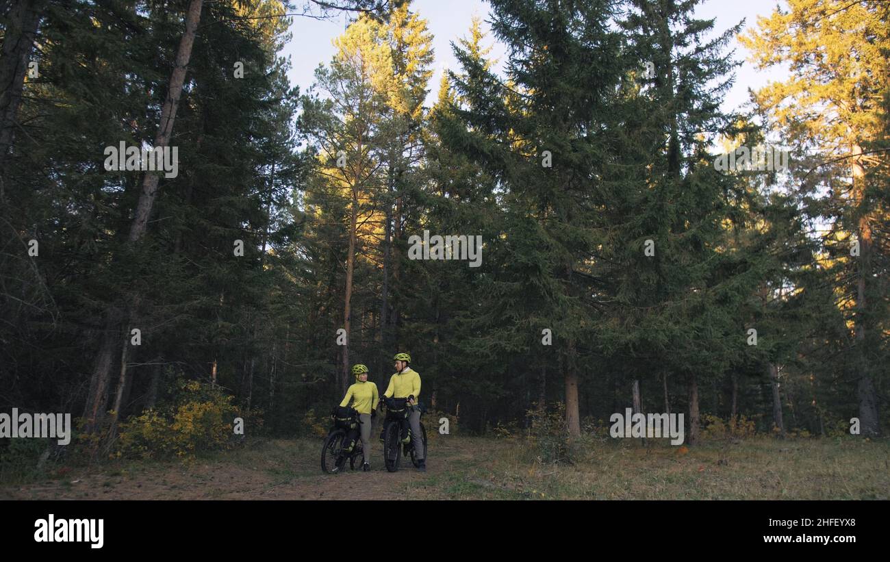 The man and woman travel on mixed terrain cycle touring with ...
