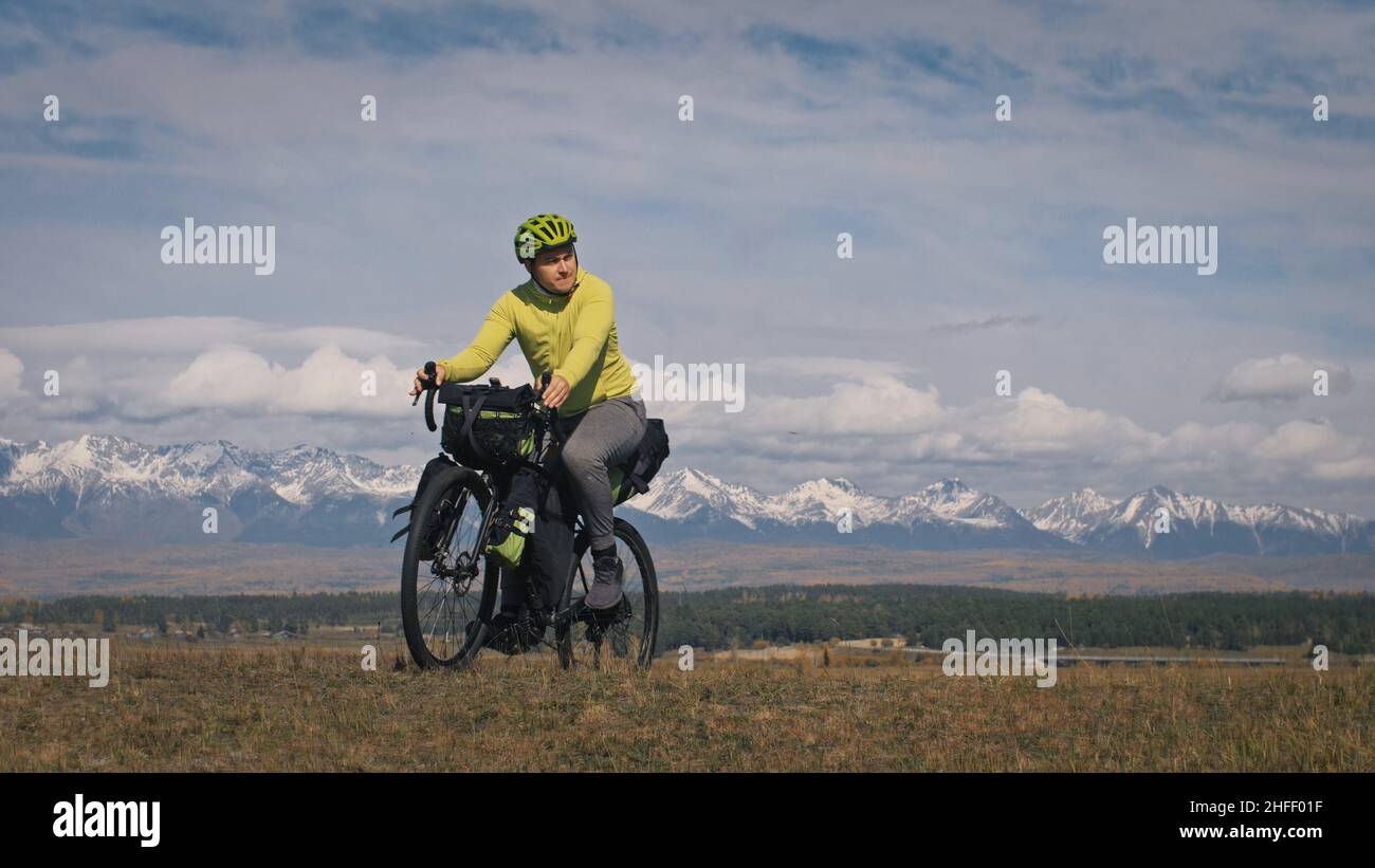 The man travel on mixed terrain cycle touring with bikepacking. The ...