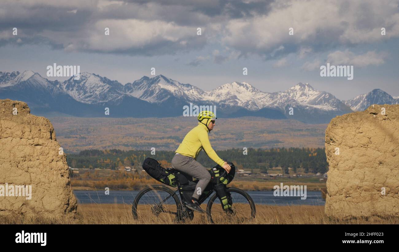 The man travel on mixed terrain cycle touring with bikepacking. The ...