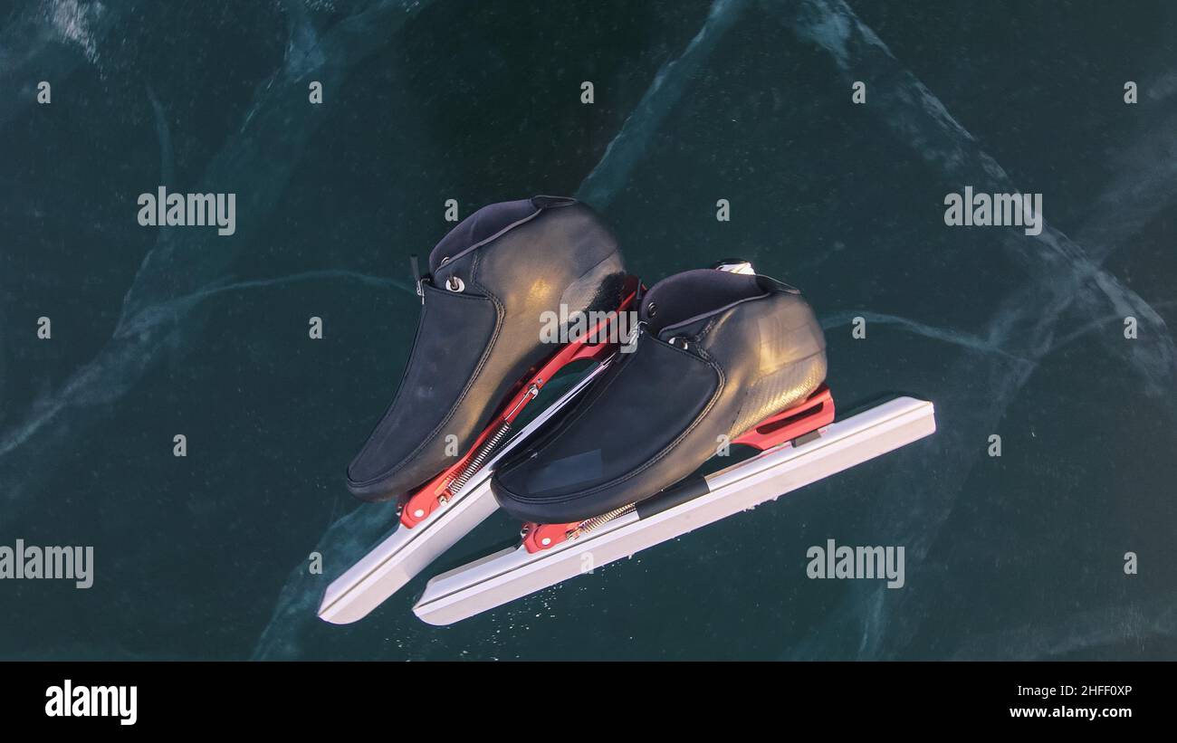 The skates are on the ice. The child train on ice speed skating. The ...