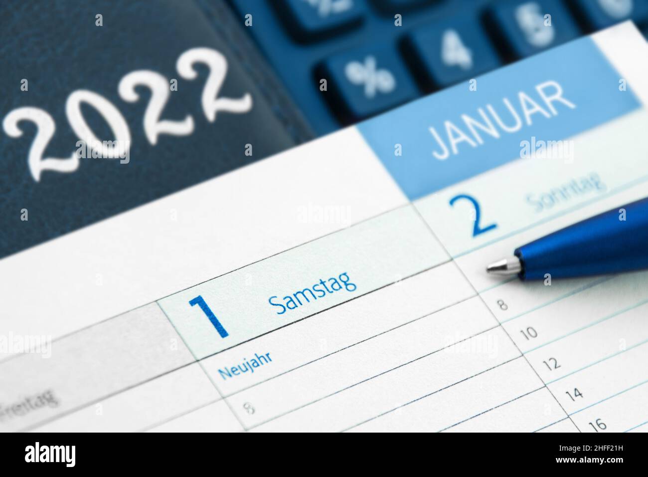 German calendar 2022 and calculator with pencil January 1 Saturday and ...