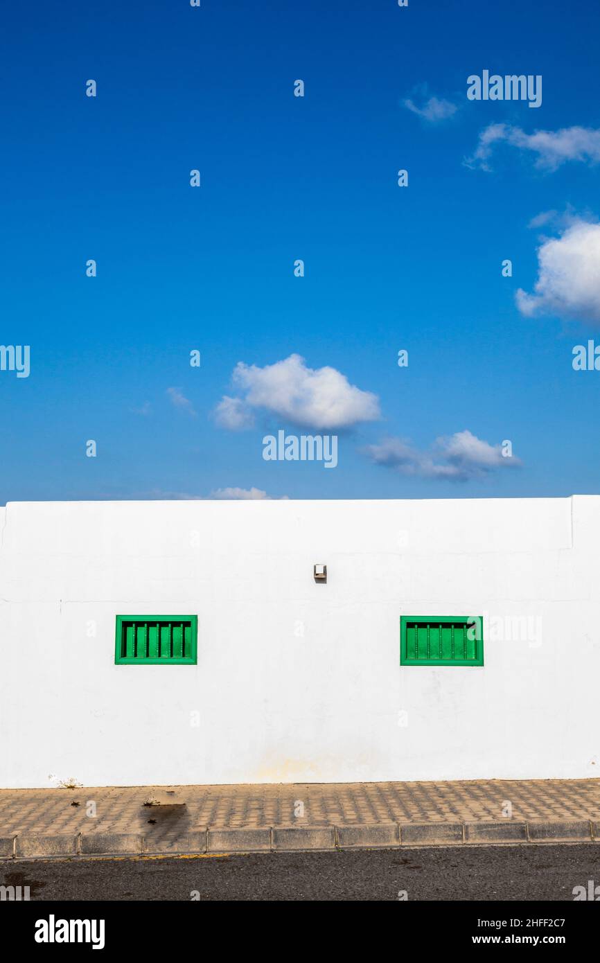 facade of mediterranean house with closed shutterblinds at midday Stock Photo - Alamy