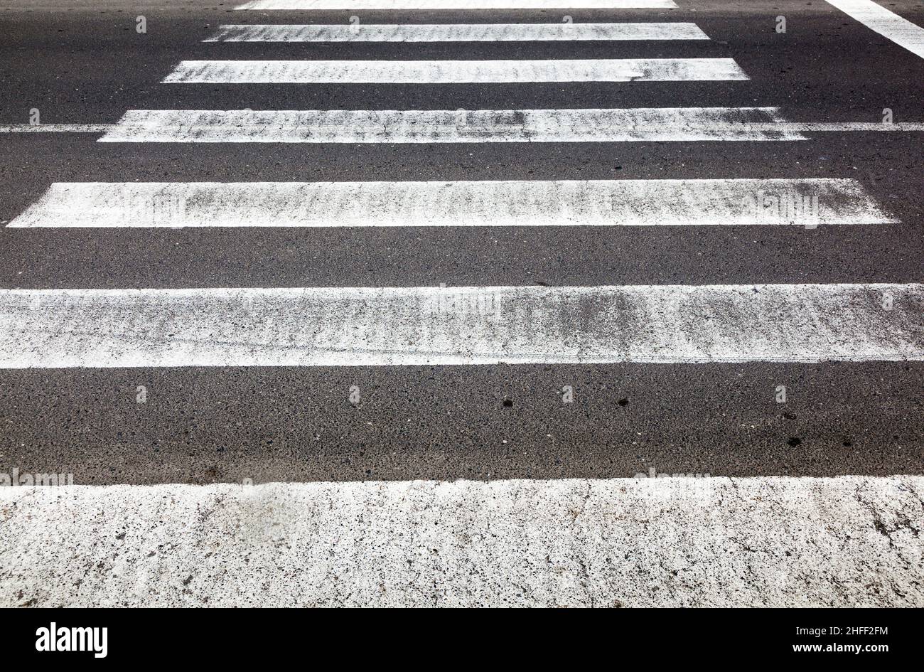 old rotten pedestrian crossing stripes at the street Stock Photo - Alamy