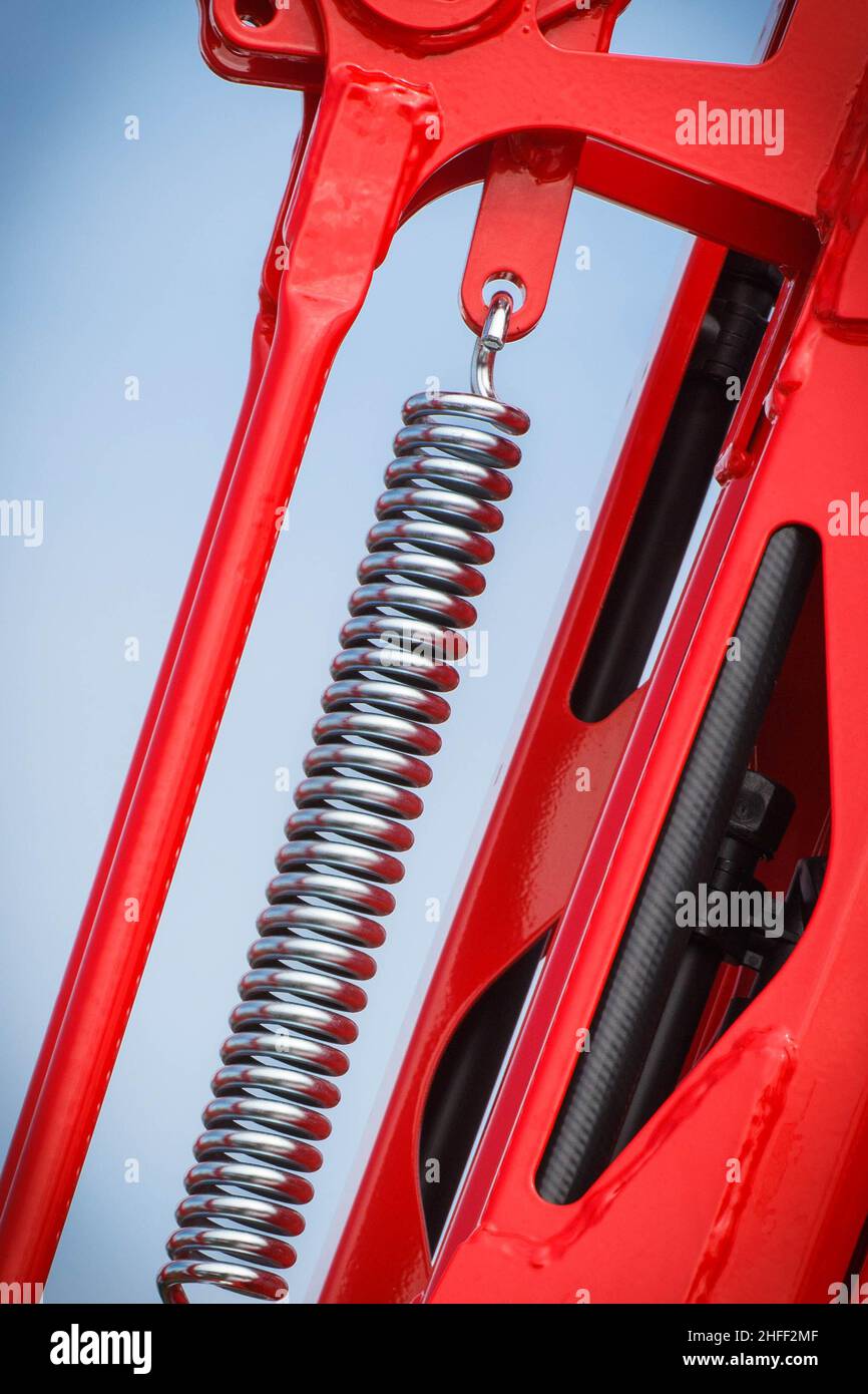 Hard spring made of steel on blue sky background. Part and detail of ...
