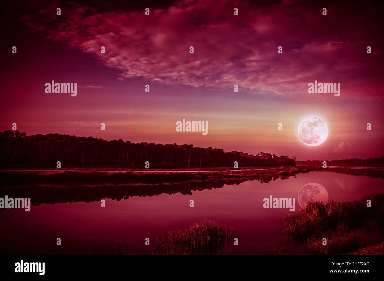 Beautiful landscape of red sky with cloud and full moon above ...