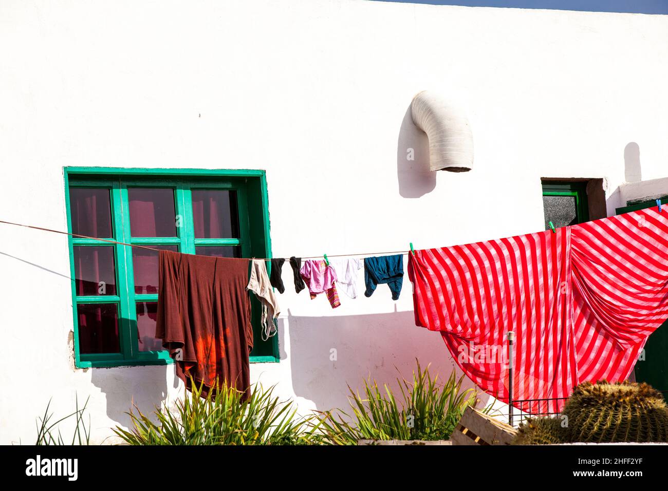 clothes drying in front of a fishermans house at the harbor Stock Photo ...