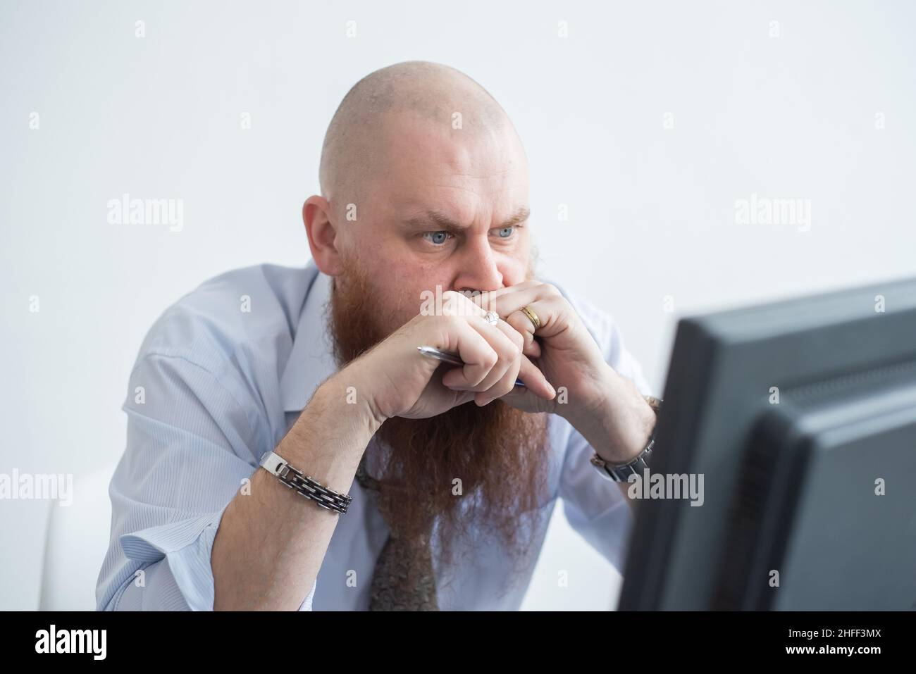 Problems for the office worker. A bald man in a white shirt sits at a ...