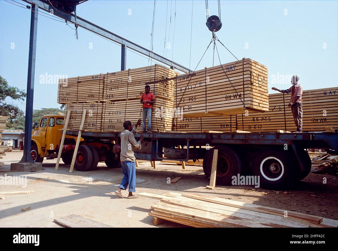Transshipment of stacks of timber ready for export at the timber ...