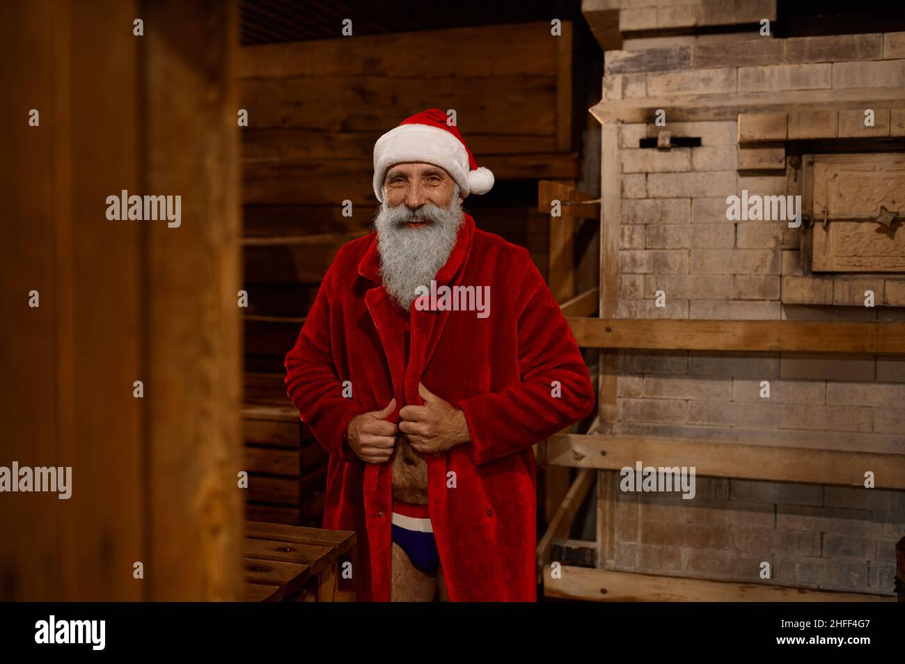 Santa Claus wrapped in bathrobe feeling cold Stock Photo - Alamy