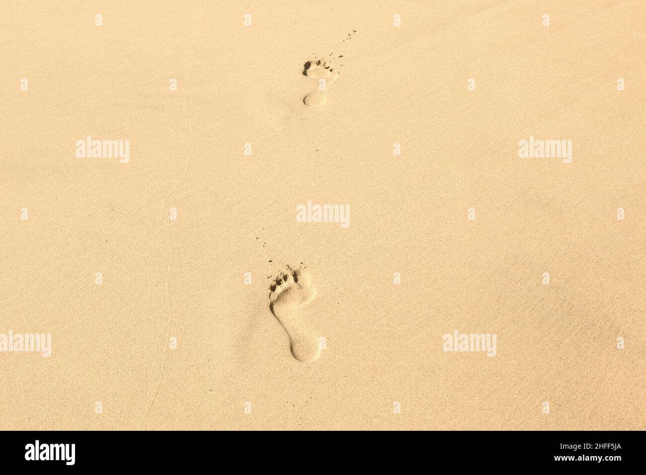 human footsteps at the clean sandy beach Stock Photo - Alamy