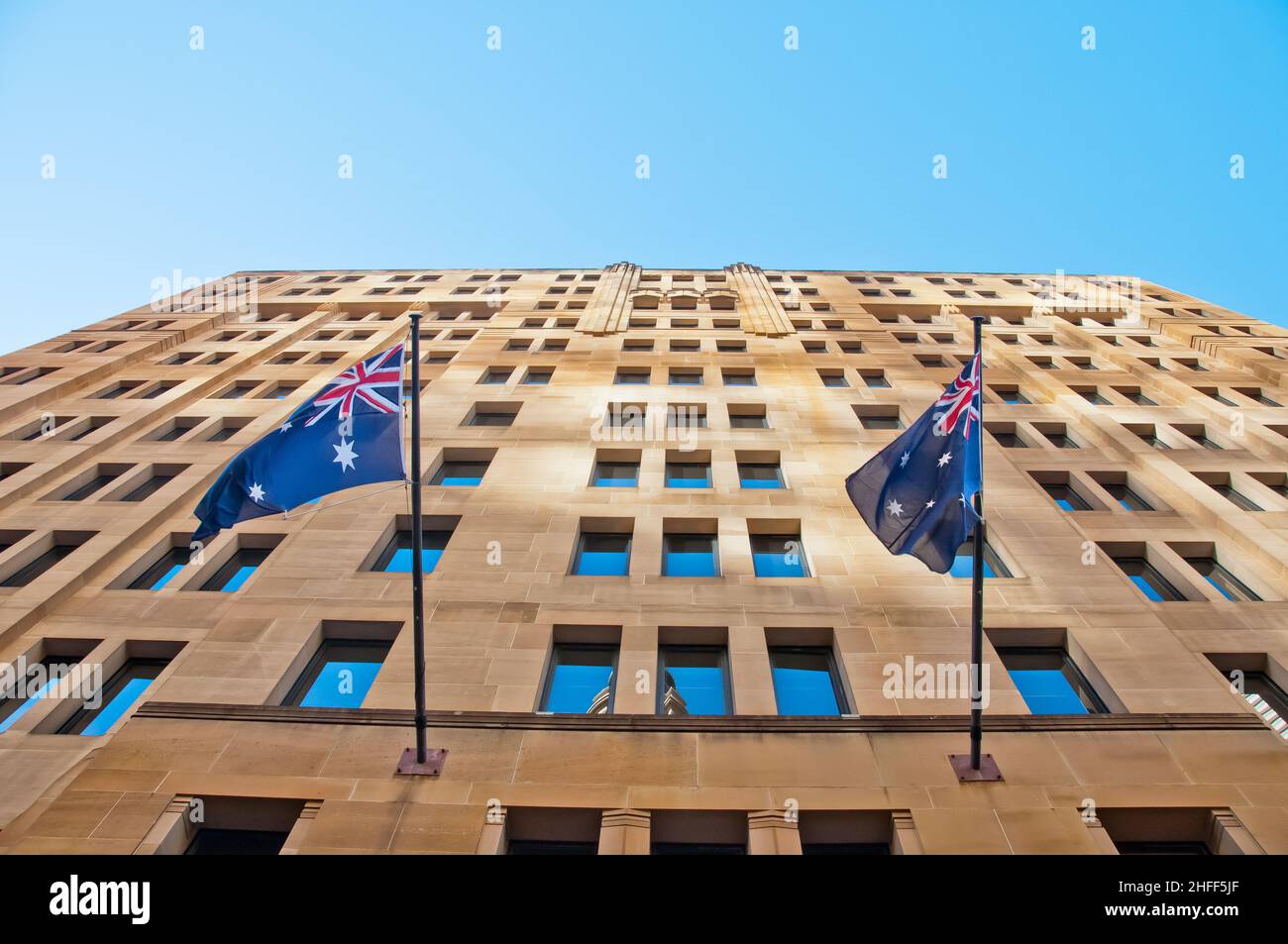 Two Australia flags hanging from a sandstone building Stock Photo - Alamy