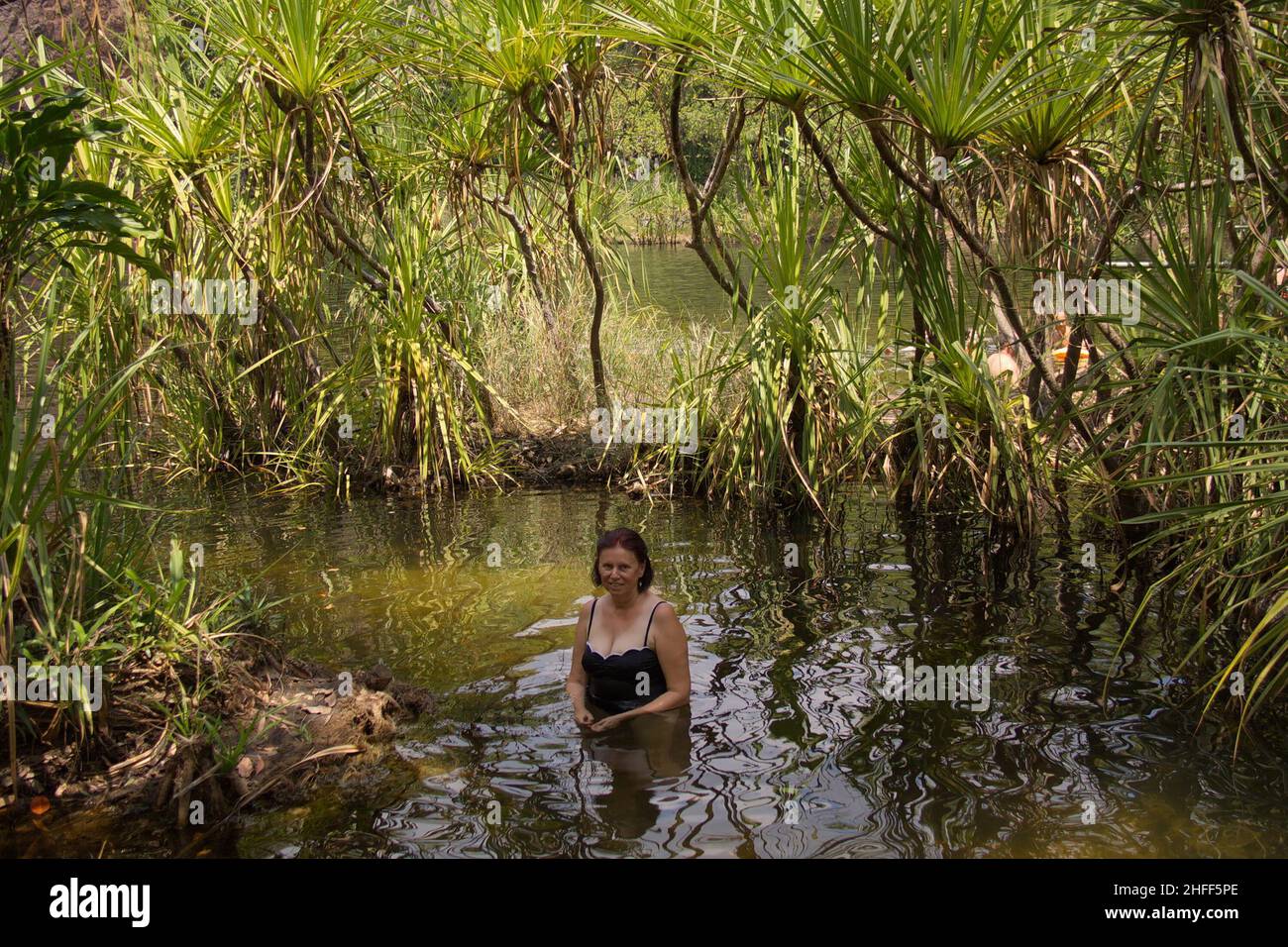 Woman bathing at Tjaynera Falls in Litchfield National Park in Northern ...