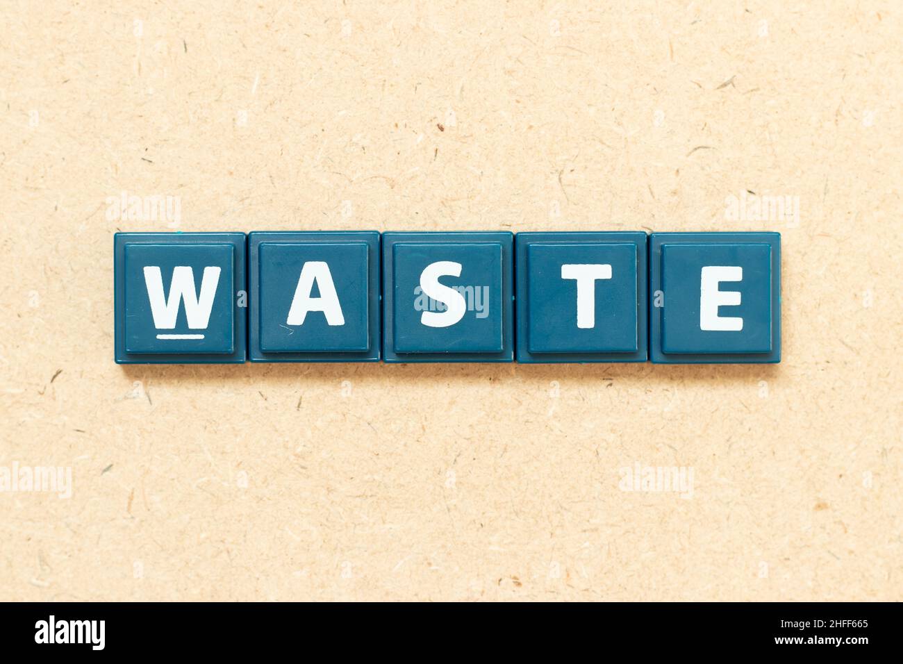 Tile alphabet letter in word waste on wood background Stock Photo - Alamy