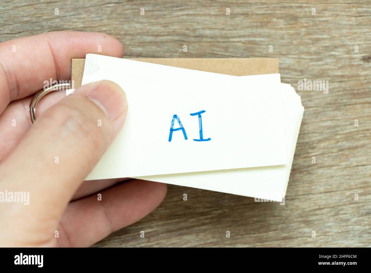 Man hold the flash card with handwriting word AI (Abbreviation of ...