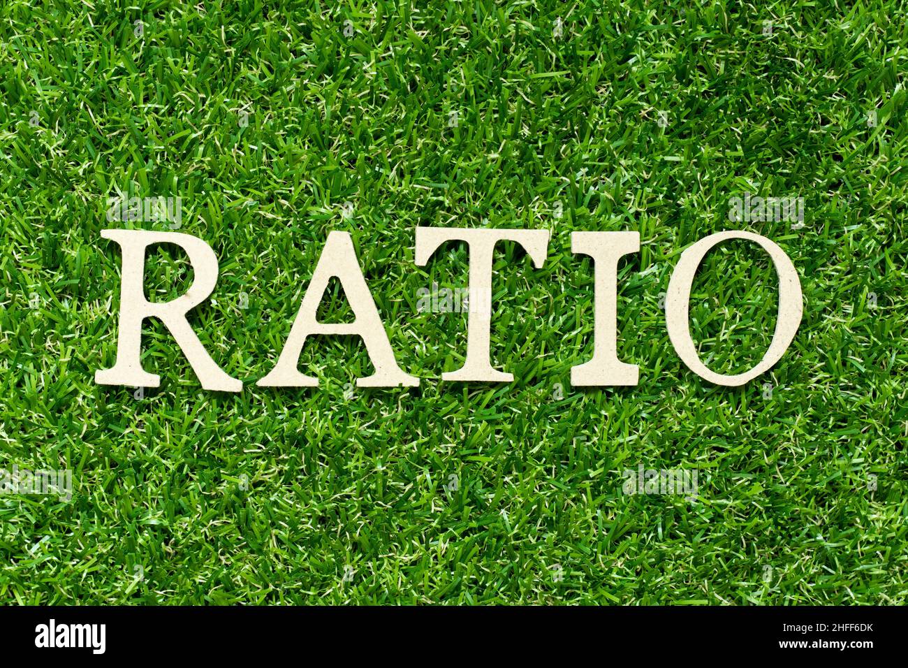 Wood letter in word ratio on green grass background Stock Photo - Alamy