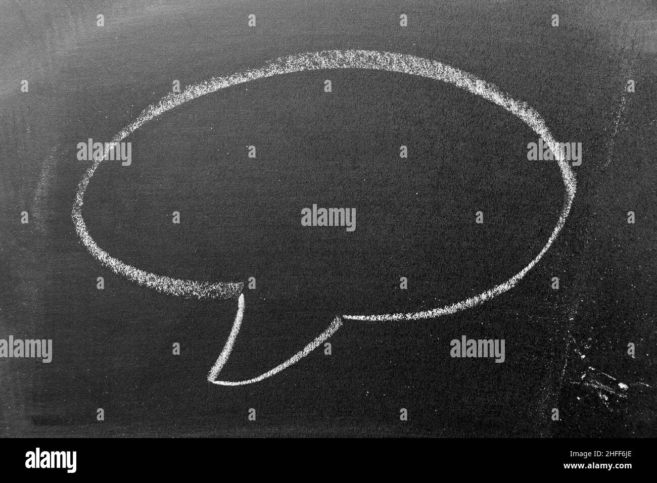 White color chalk hand drawing in round bubble speech shape with blank ...