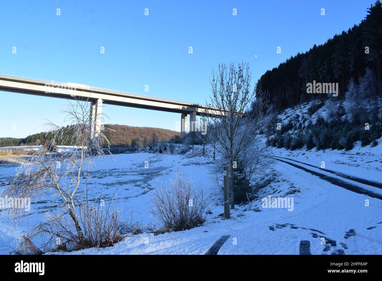 Autobahn bridge of the A1 near Daun and Rengen above snowy landscape ...