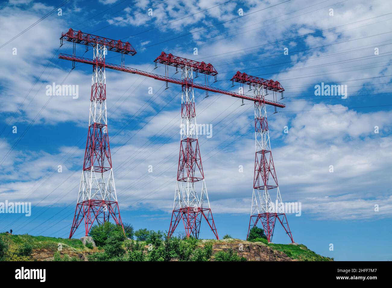 Electricity transmission towers on the river bank. Summer landscape ...