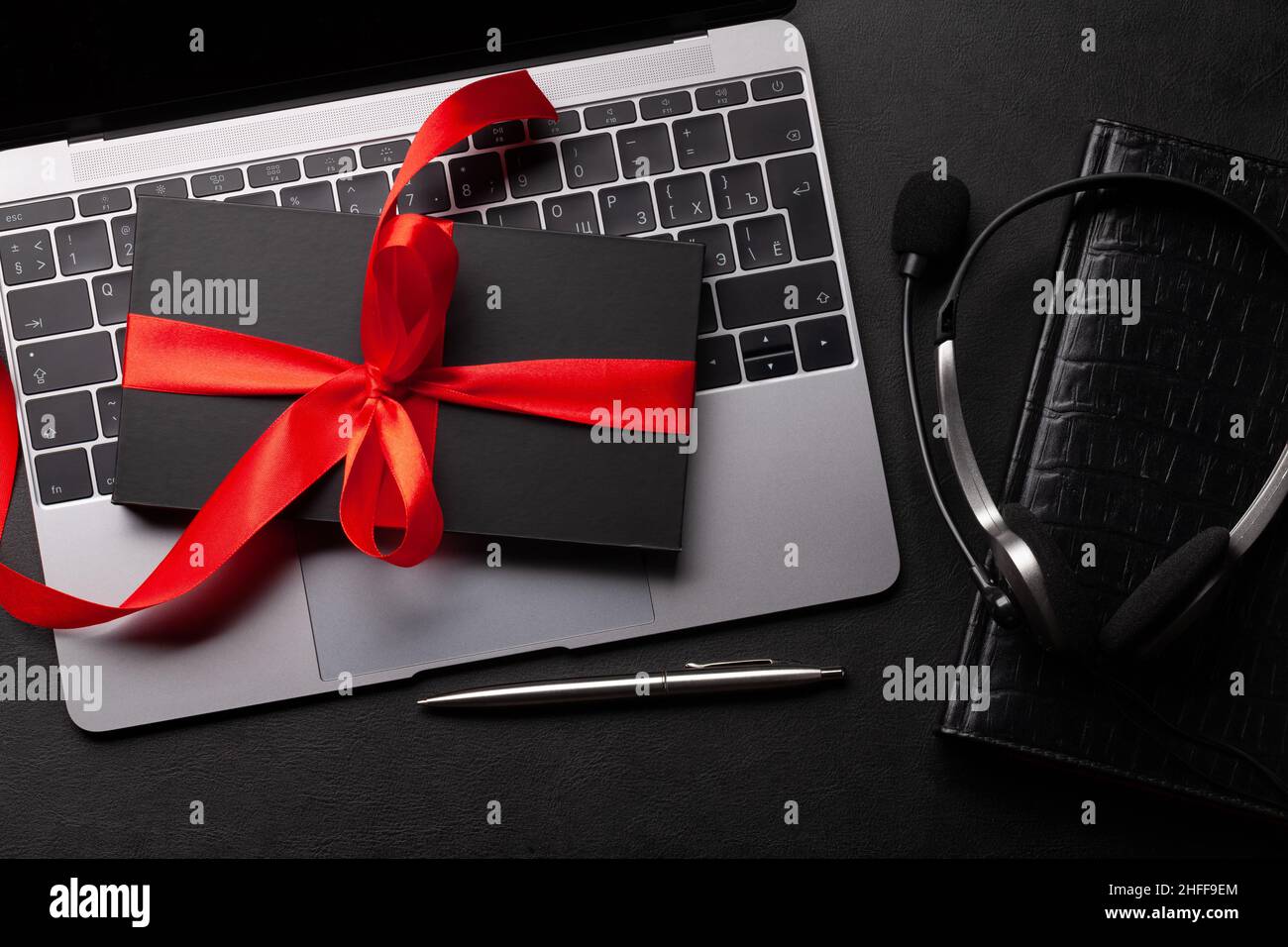 Gift box over laptop on office desk table. Top view flat lay with copy ...
