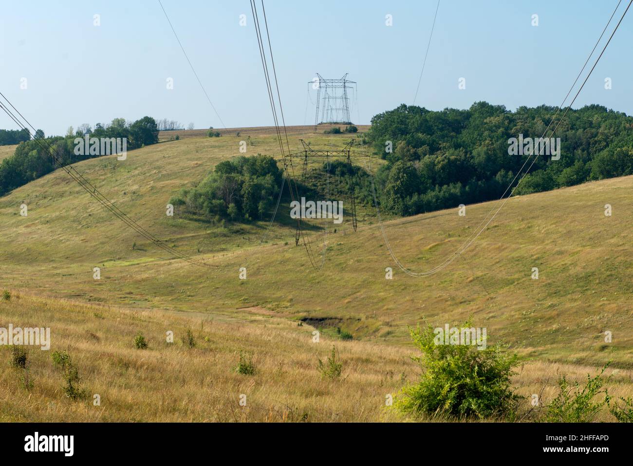 High voltage power line over a high hills Stock Photo - Alamy