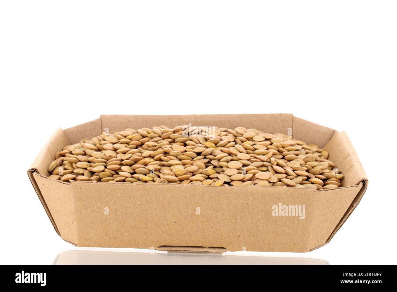 Raw organic green lentils in a paper box, macro, isolated on white ...