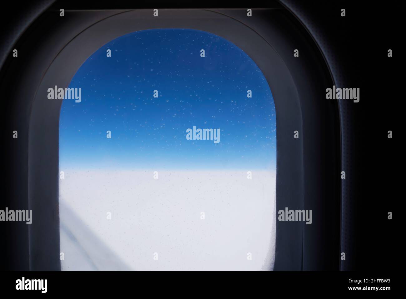 Window in an Aircraft in flight, dark background, blue sky Stock Photo ...