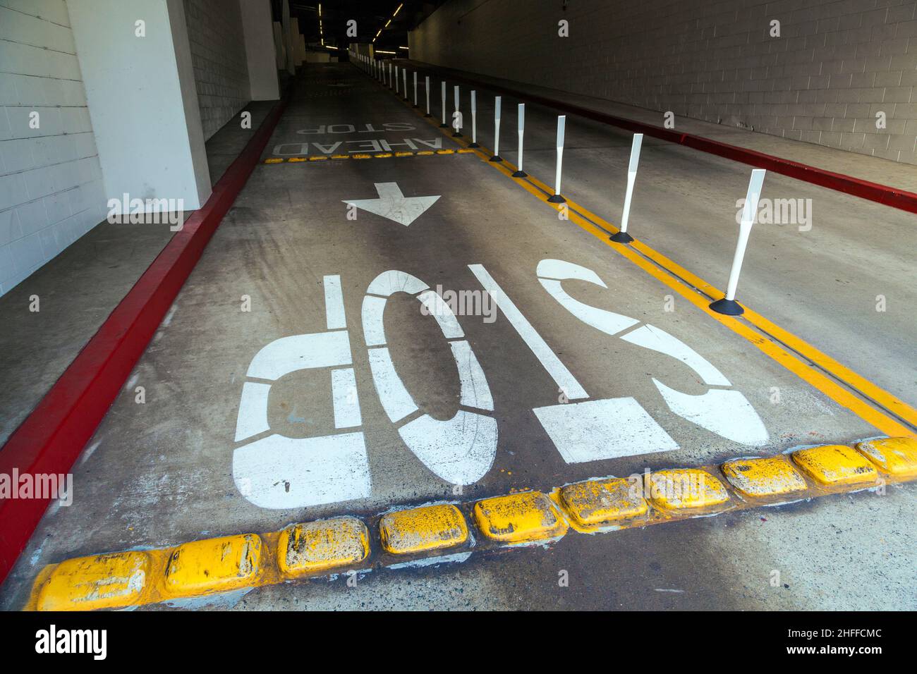 stop sign in a garage painted on the asphalt Stock Photo - Alamy