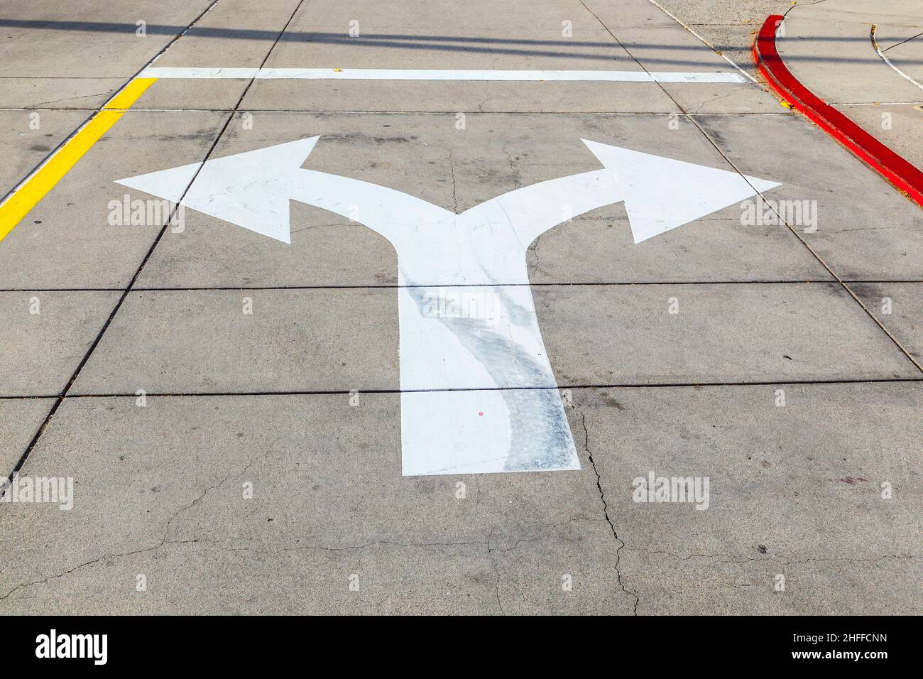 arrows and lines on the asphalt to indicate the direction of driving ...