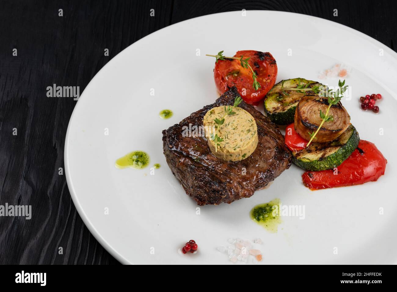 Grilled black angus strip loin steak with vegetables Stock Photo - Alamy
