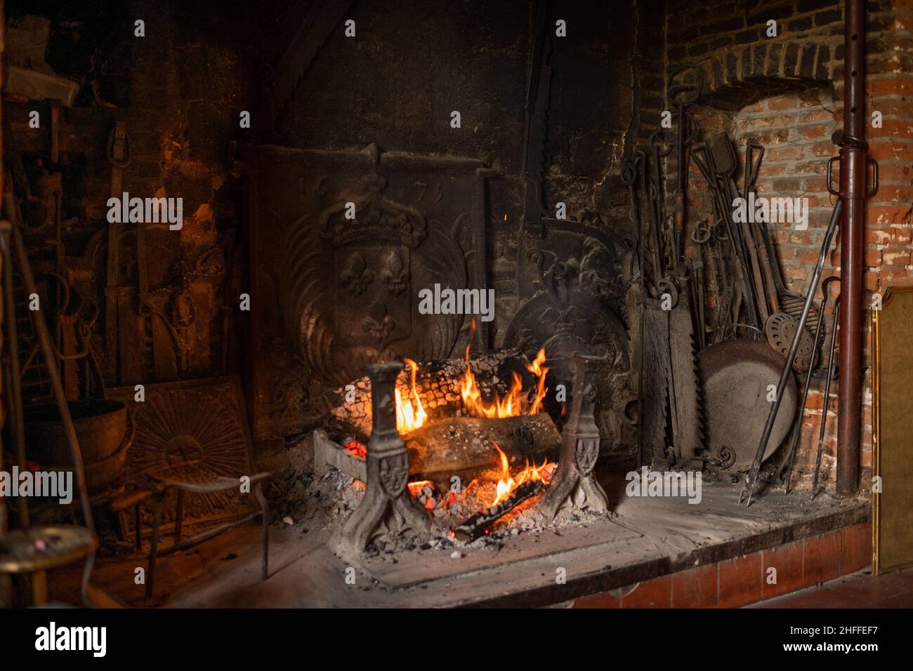 Fireplace and bonfire with firewood in an old French house Stock Photo ...