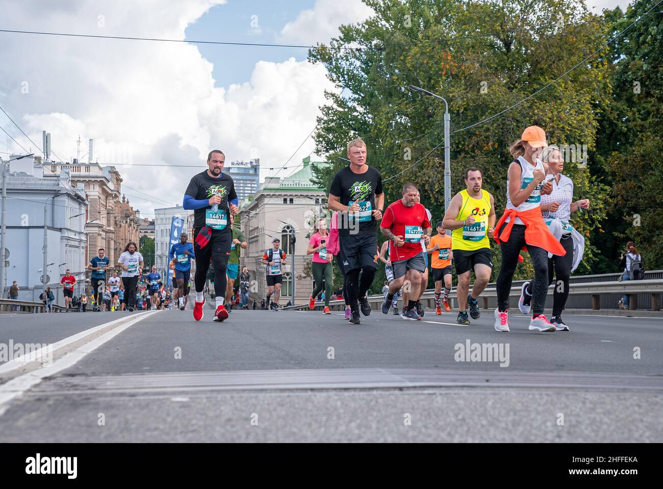 Large group of men runners running marathon Stock Photo - Alamy