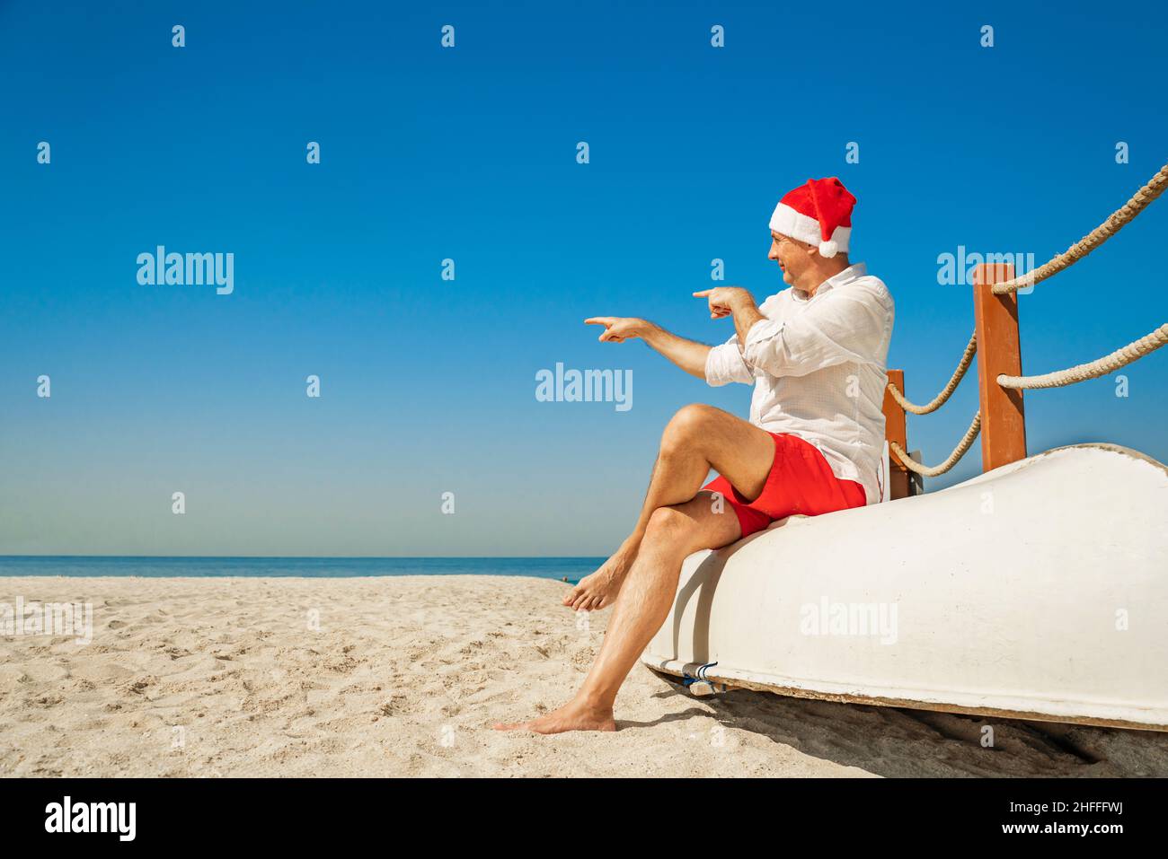 Christmas Santa Claus resting on at ocean sandy tropical beach sitting ...