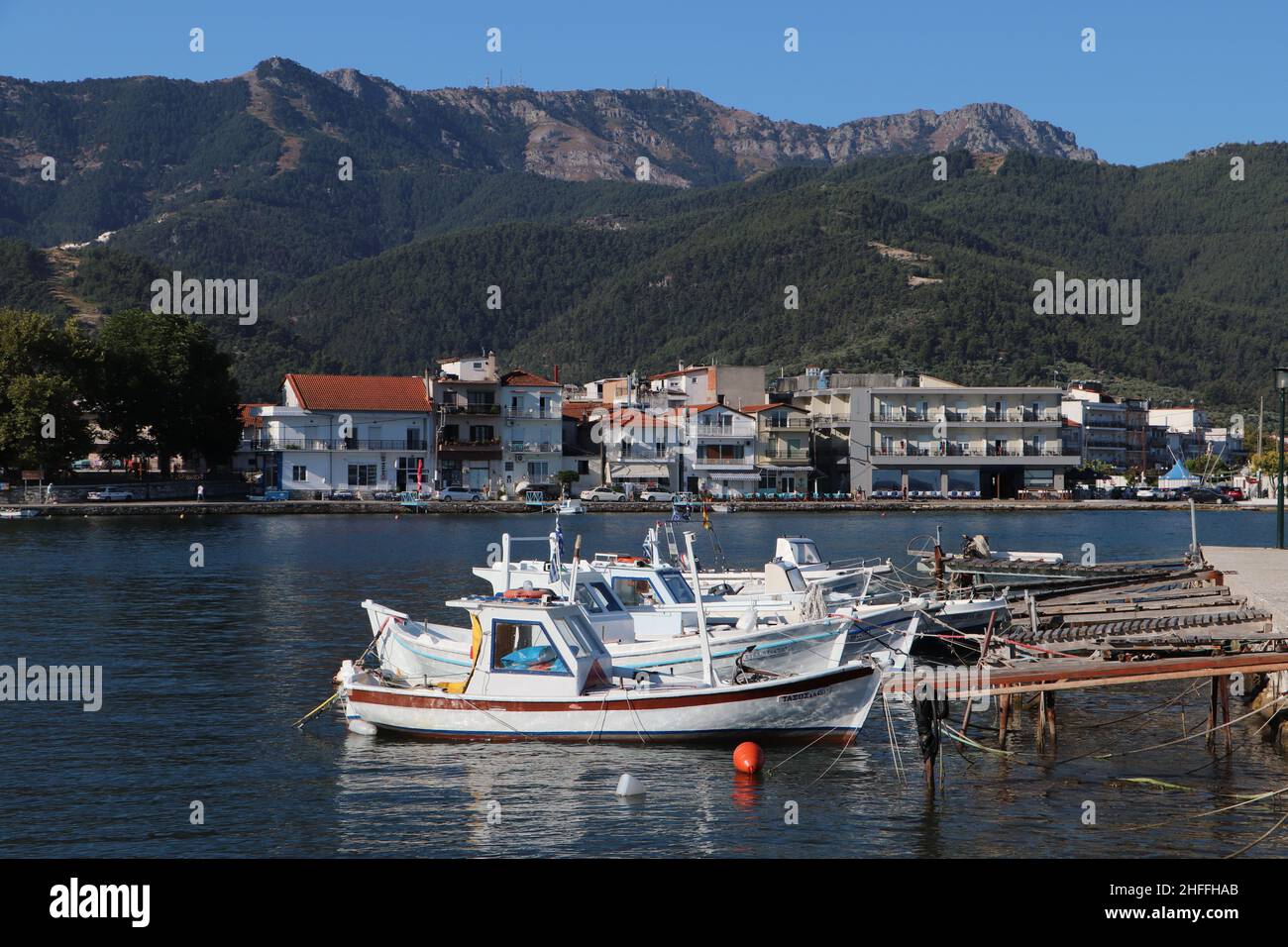 Boats in the old harbor of Limenas city Stock Photo - Alamy