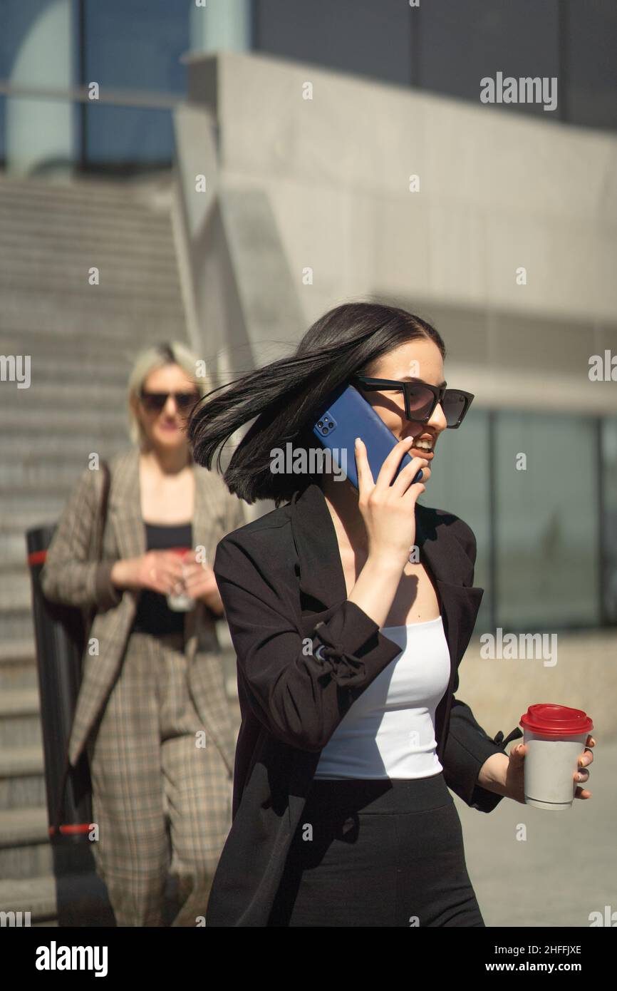 Business woman is talking on the phown while smiling Stock Photo - Alamy