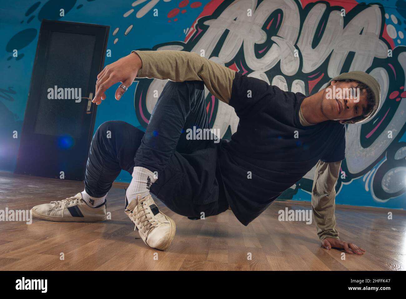 Modern rapper dancing in garage. Urban lifestyle, hip hop Stock Photo ...