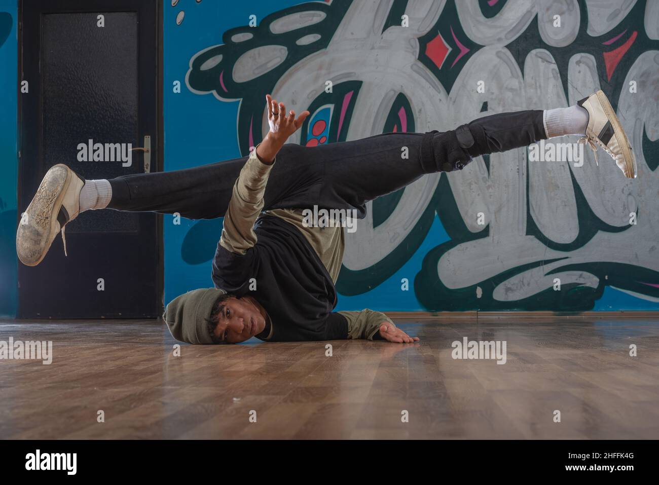 Modern rapper dancing in garage. Urban lifestyle, hip hop Stock Photo ...