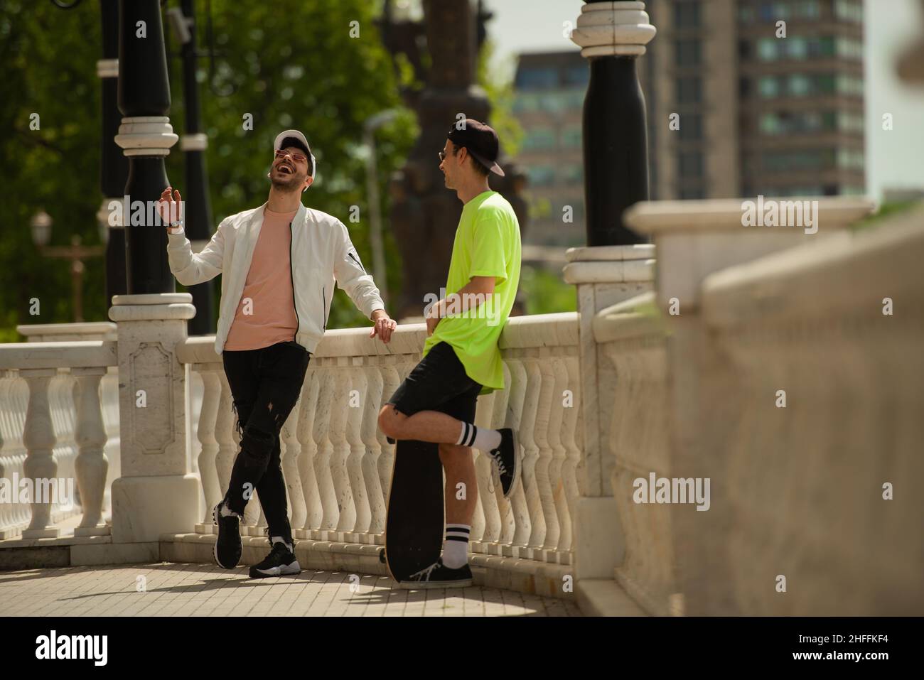 Two handsome and fit guy friends are laughing while talking Stock Photo ...