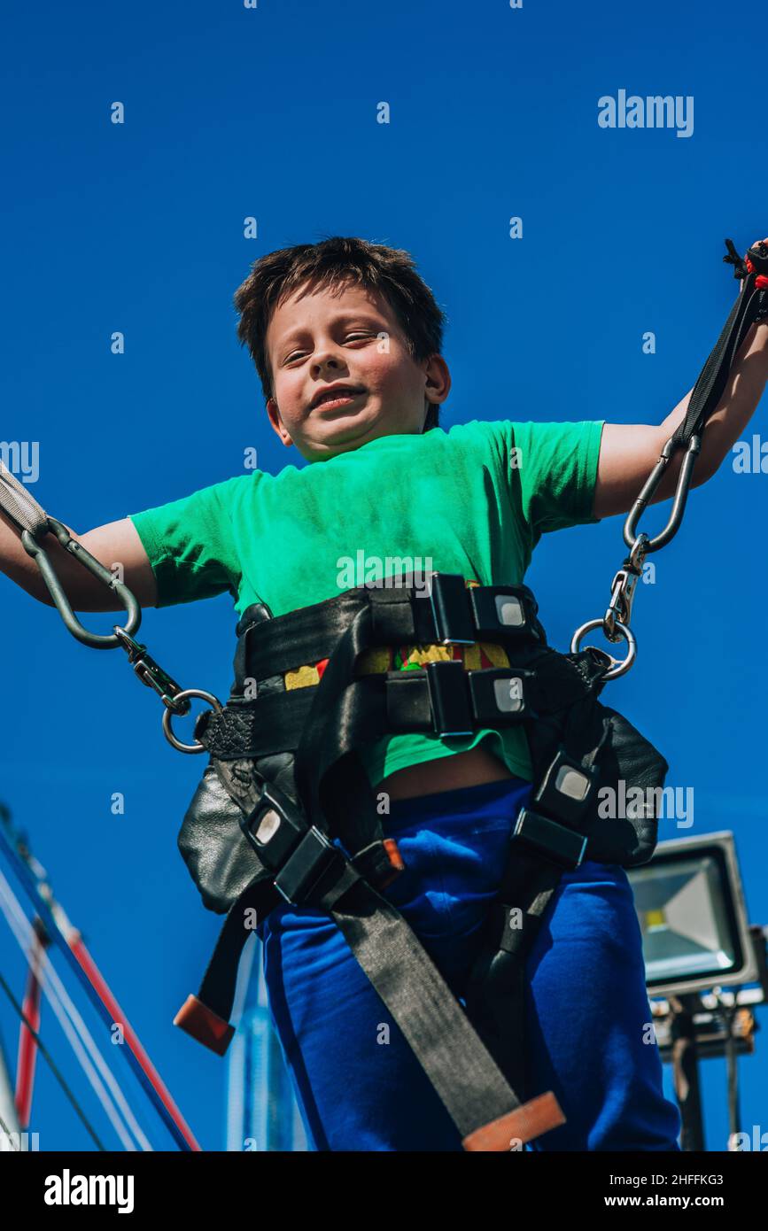 Child jumping on the trampoline (bungee jumping Stock Photo - Alamy