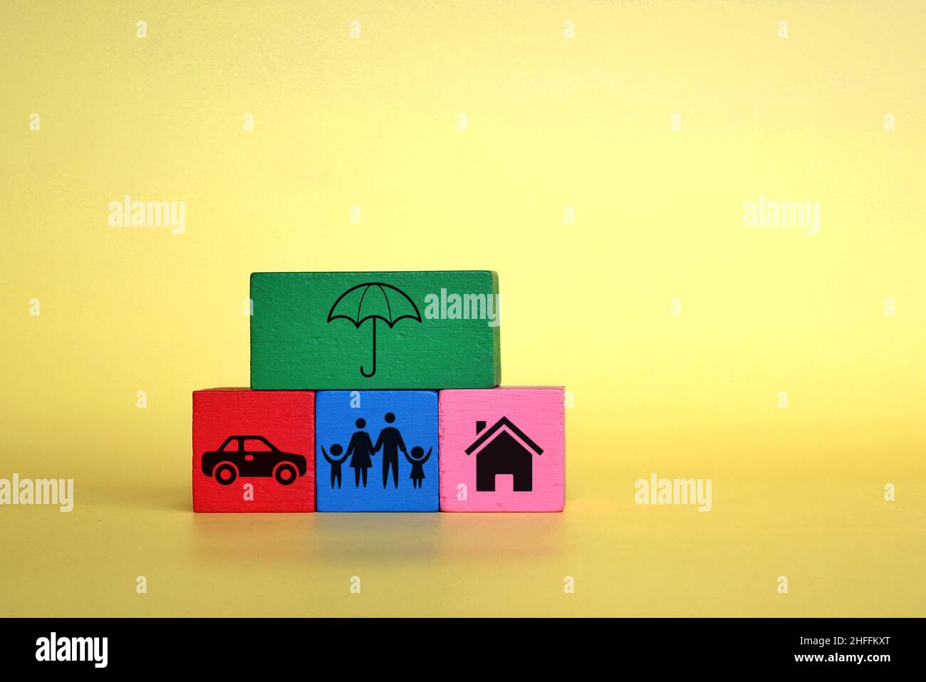 Insurance and protection concept. Wooden cubes with umbrella, car ...
