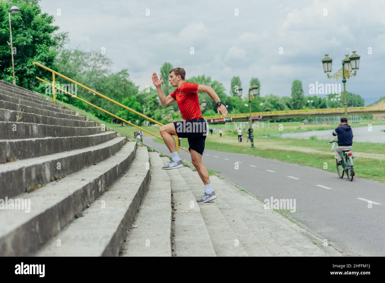 Fit male athlete performing stairs workout, running up climbing stairs ...