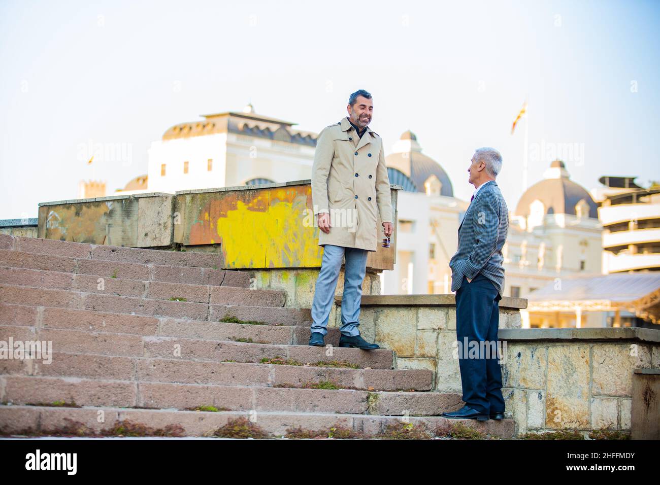 Two amazing senior businessmen are talking while smiling Stock Photo ...