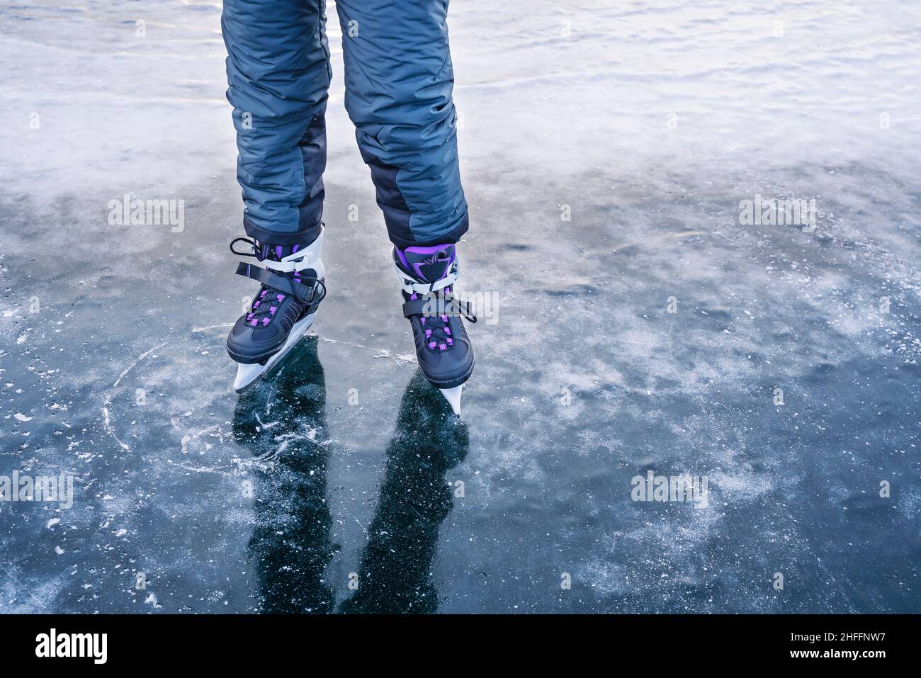 View of the beautiful transparent blue ice of frozen Baikal Lake. Human ...